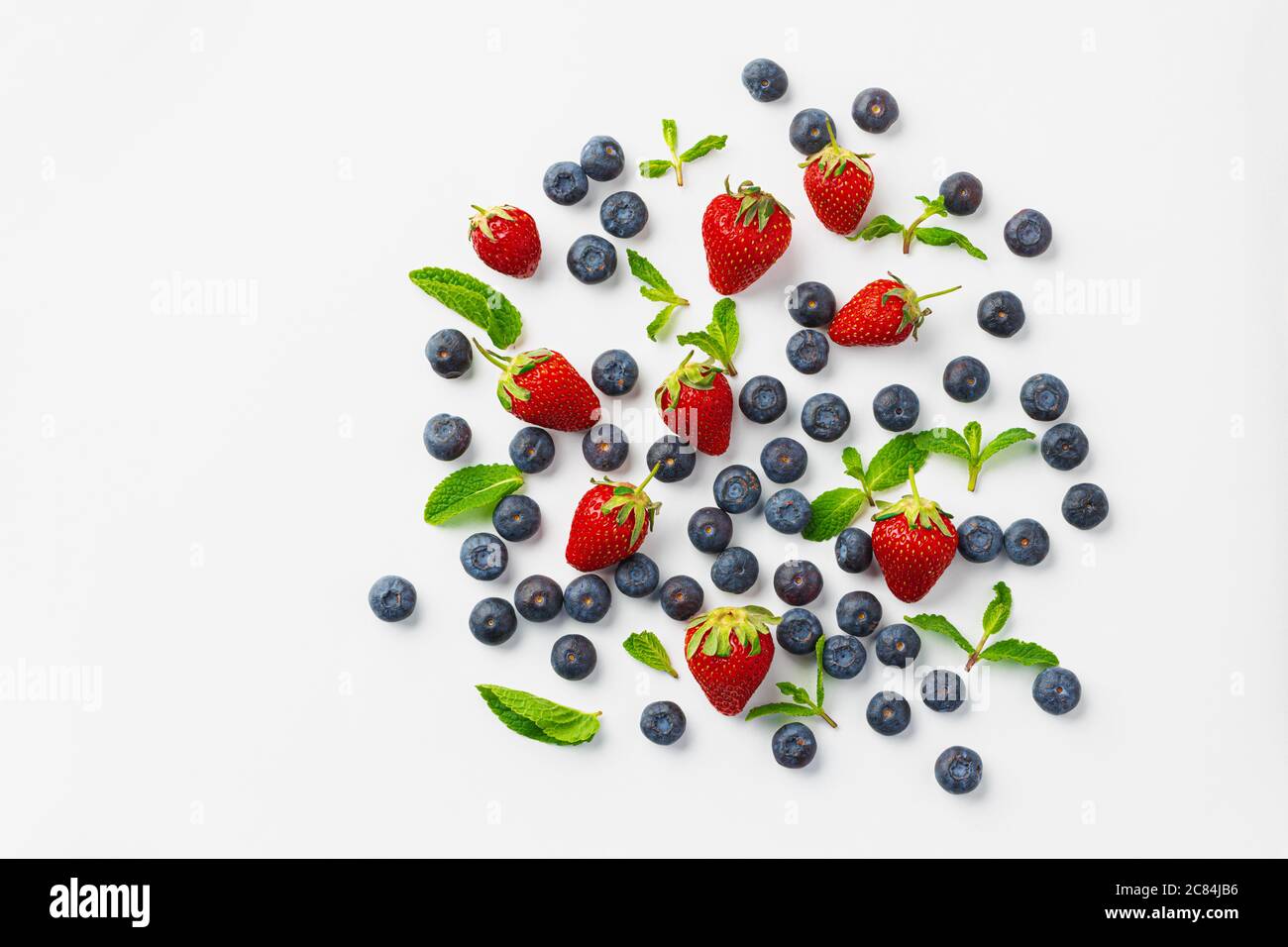 Strawberries and blueberries scattered on white background Stock Photo ...