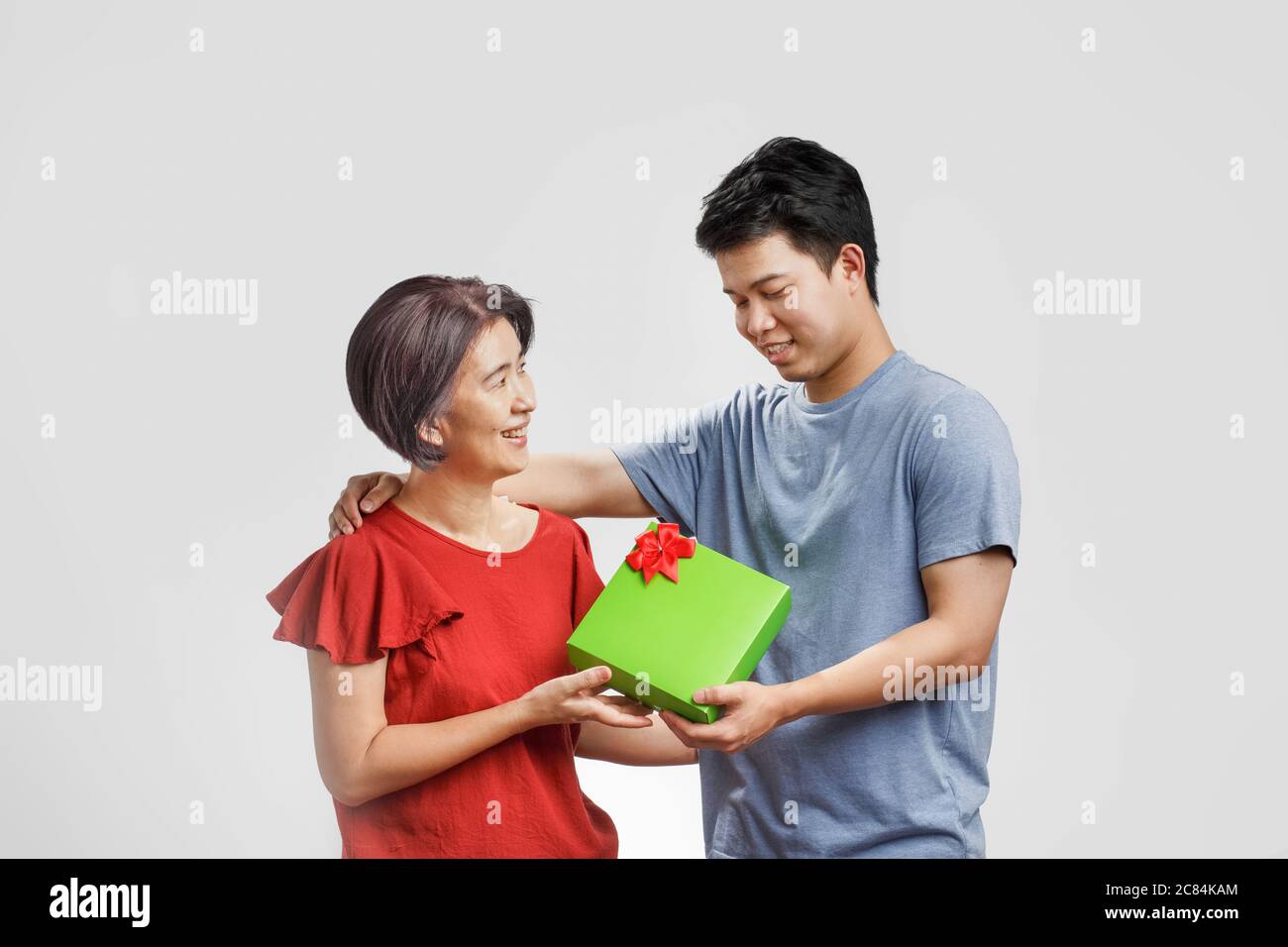 Mother day, mom receiving a gift from son Stock Photo - Alamy