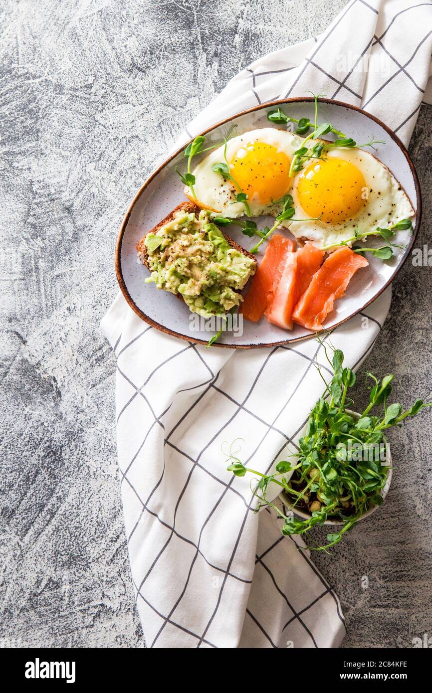 Egg breakfast. Healthy nutritious breakfast with eggs, salmon, avocado ...