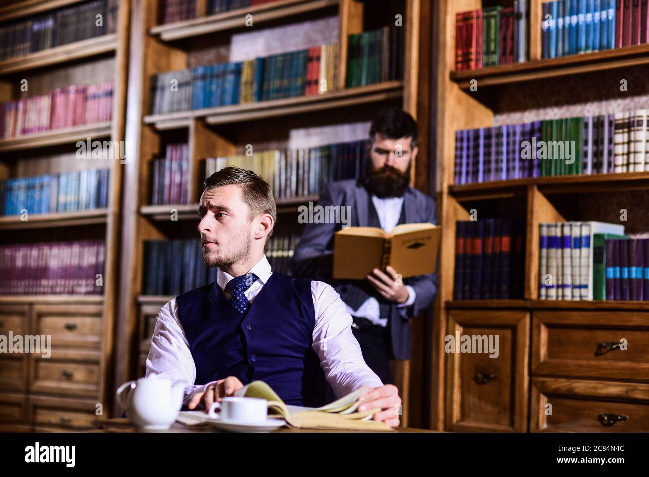 Man with strict face at tea party. Retro detectives work on ...