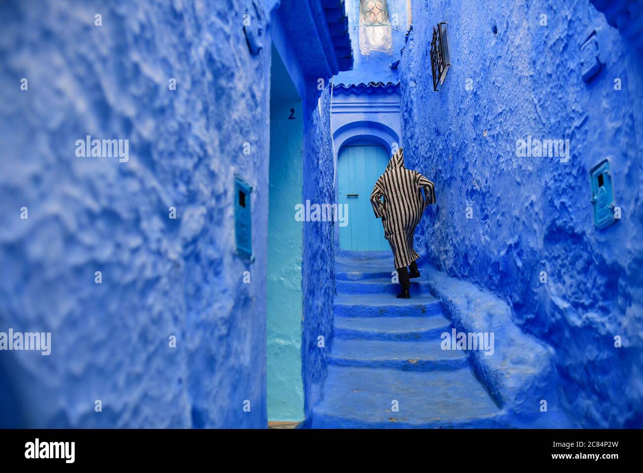 Morocco, Chefchaouen : Elderly man in black and white burnous with hood ...