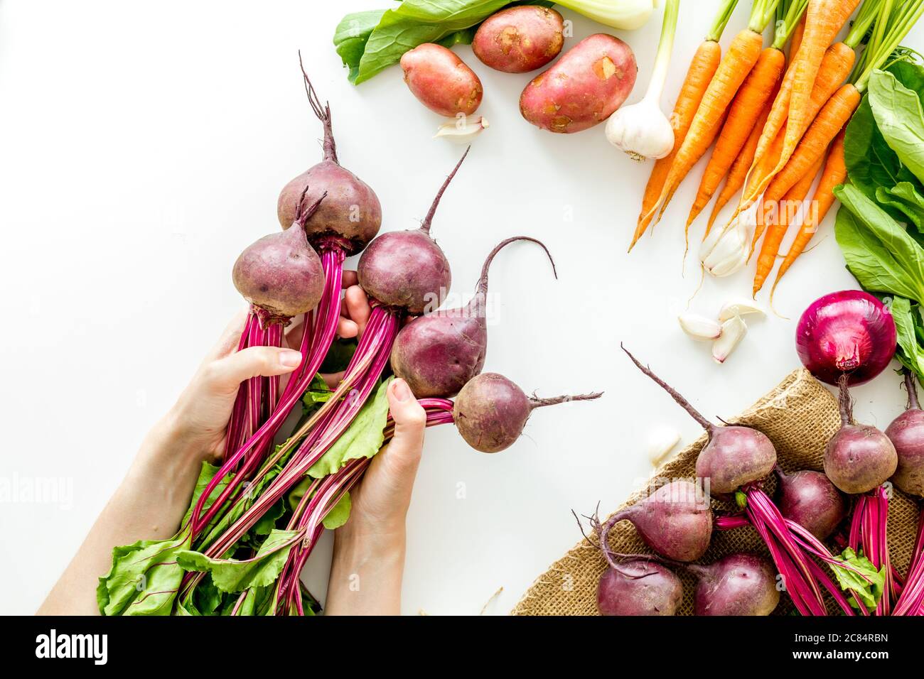 Harvest of vegetables. Hand hold beet with green tops top view Stock ...