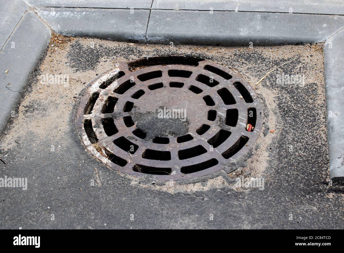 Manhole cover on the sidewalk close up, top view Stock Photo - Alamy