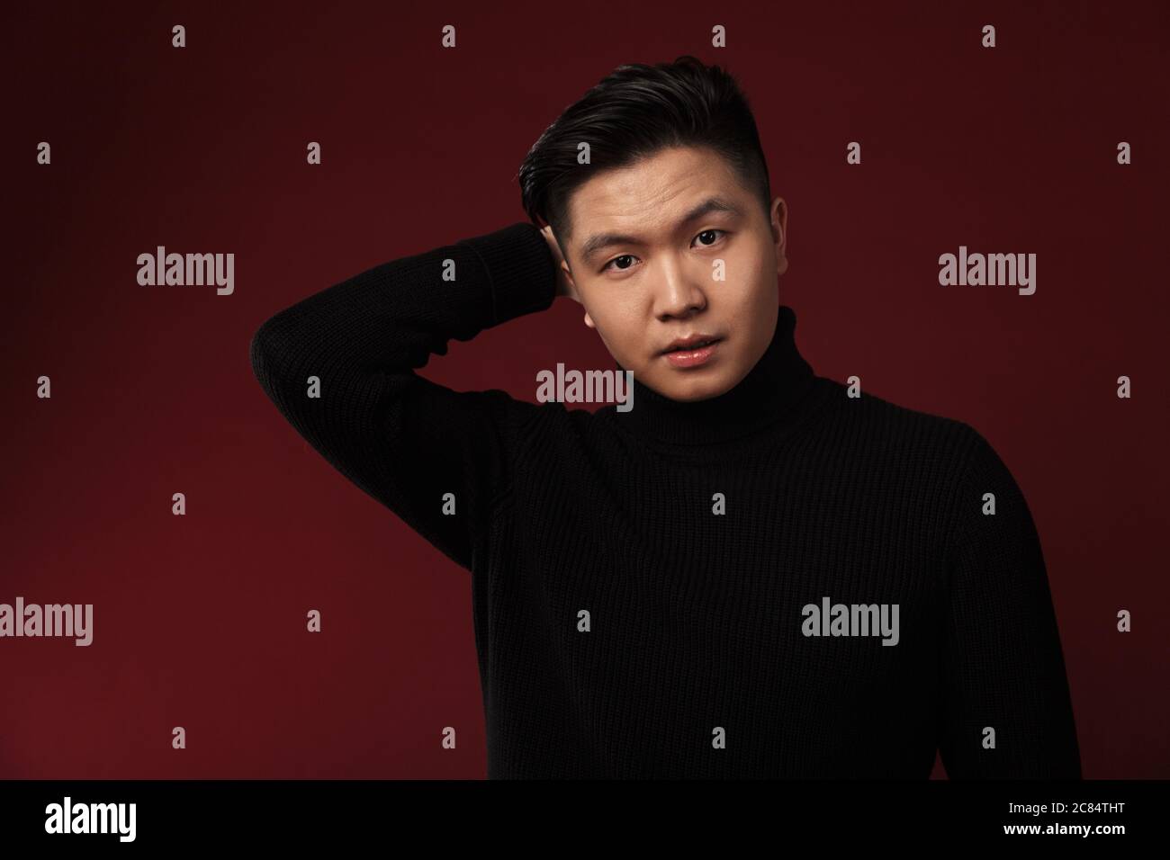 Image of confused asian man posing and looking at camera isolated over ...