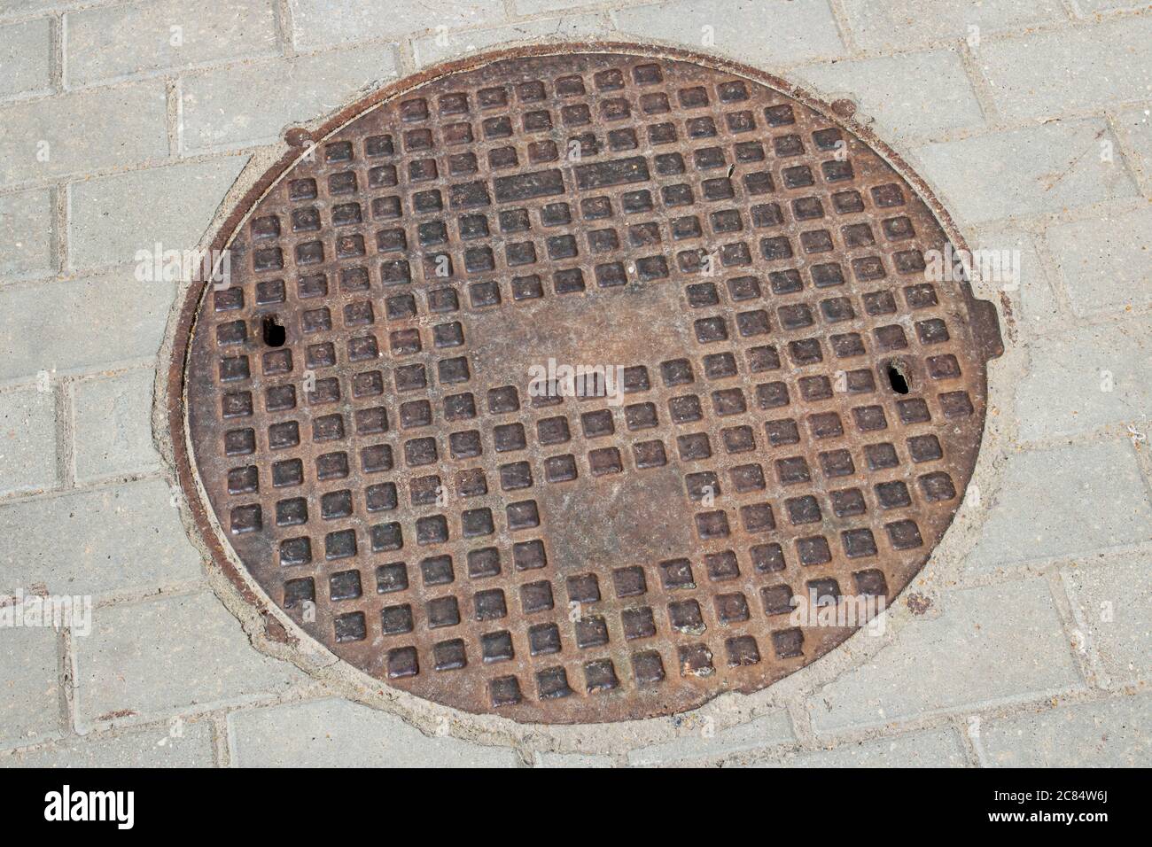 Manhole cover on the sidewalk close up, top view Stock Photo - Alamy