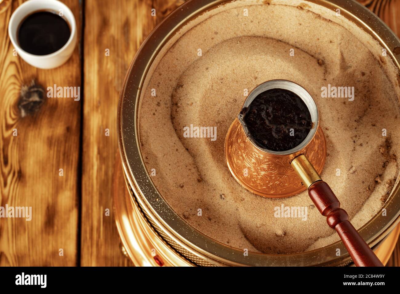 Turkish coffee in cezve on the sand Stock Photo - Alamy