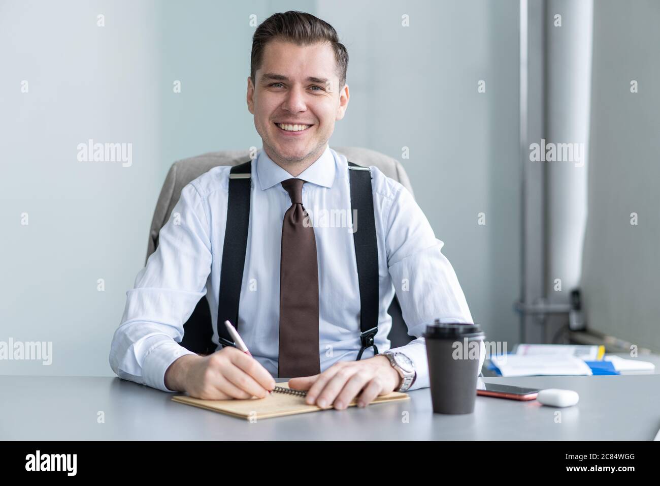 Smiling businessman sit at desk talk on webcam having videocall with ...