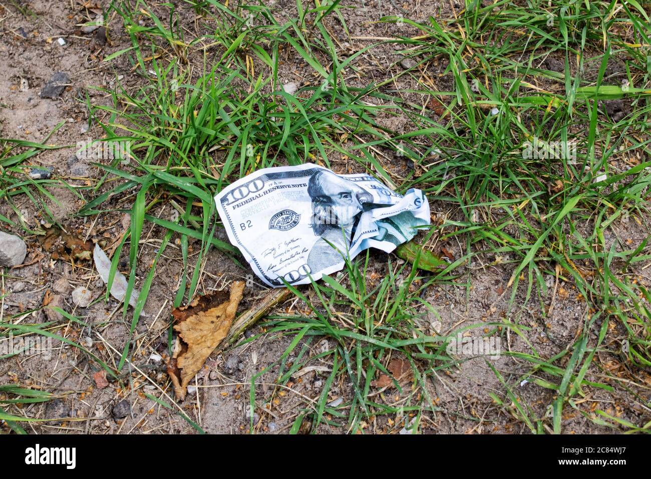 Crumpled one hundred dollar bill on the ground Stock Photo - Alamy