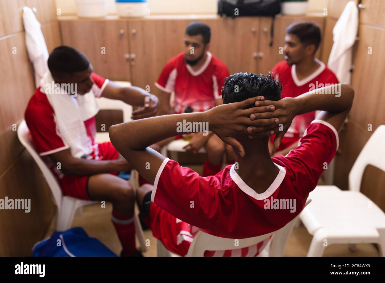 Multi ethnic group of male football players wearing a team strip ...