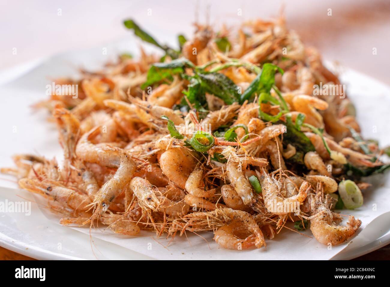 Salted fried crispy river shrimp prawn, Macrobrachium nipponense, in a ...