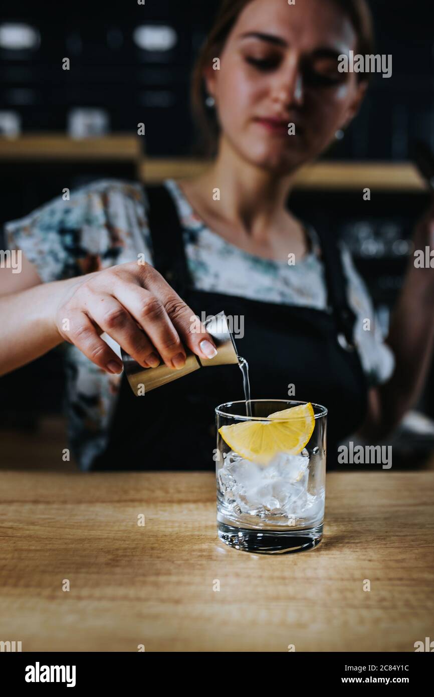 Barista girl prepares a refreshing summer version of iced and syrup ...