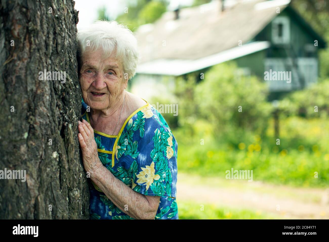 Old woman standing hi-res stock photography and images - Alamy
