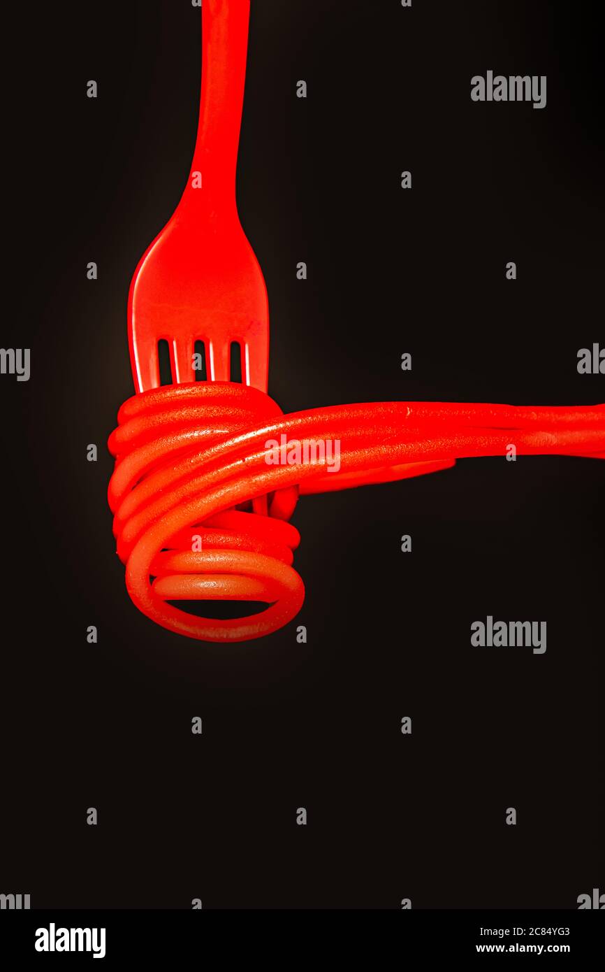 Spaghetti new defined. Hot red spaghetti on a red fork on black ...