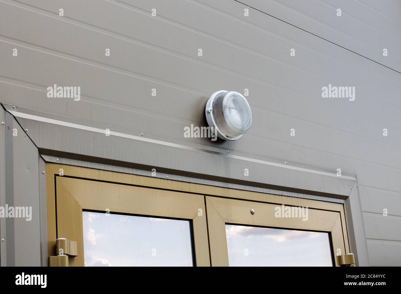 Lamp above the front door on the facade of the building Stock Photo - Alamy