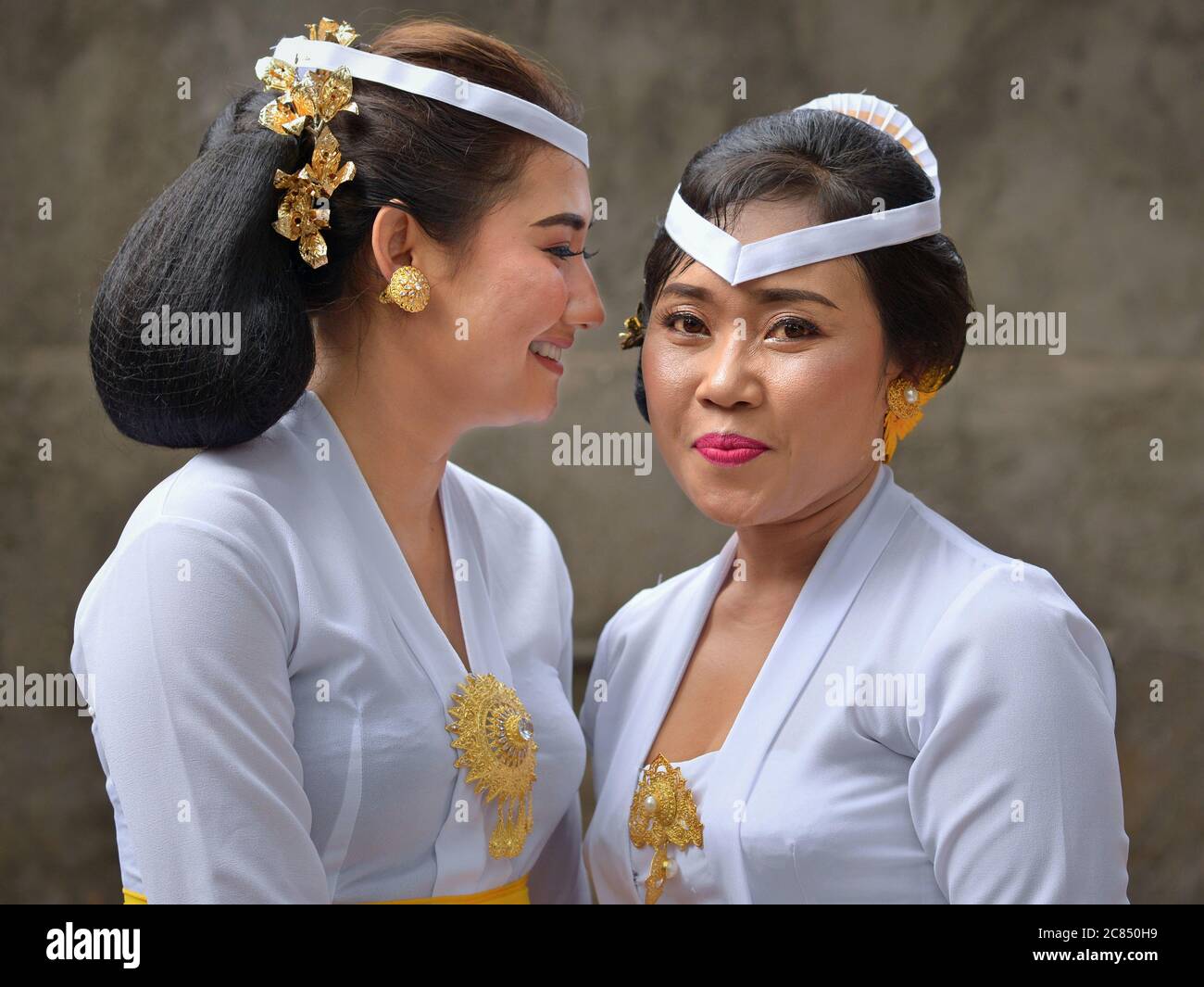 Two Dressed Up Young Indonesian Balinese Women Wear White Outfit And