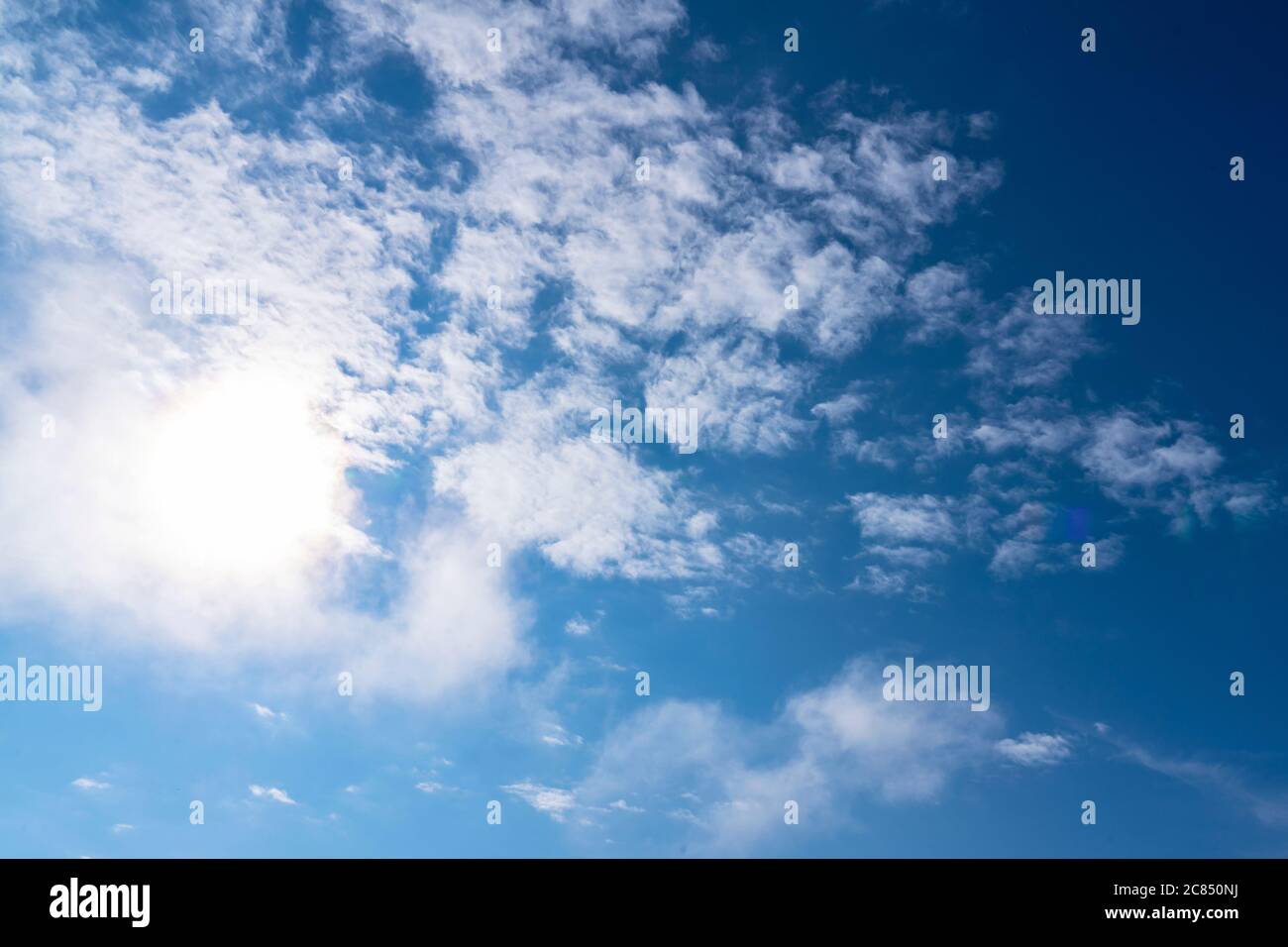 Cirrus clouds in a blue sky, taken on a summer day. the sun shines ...