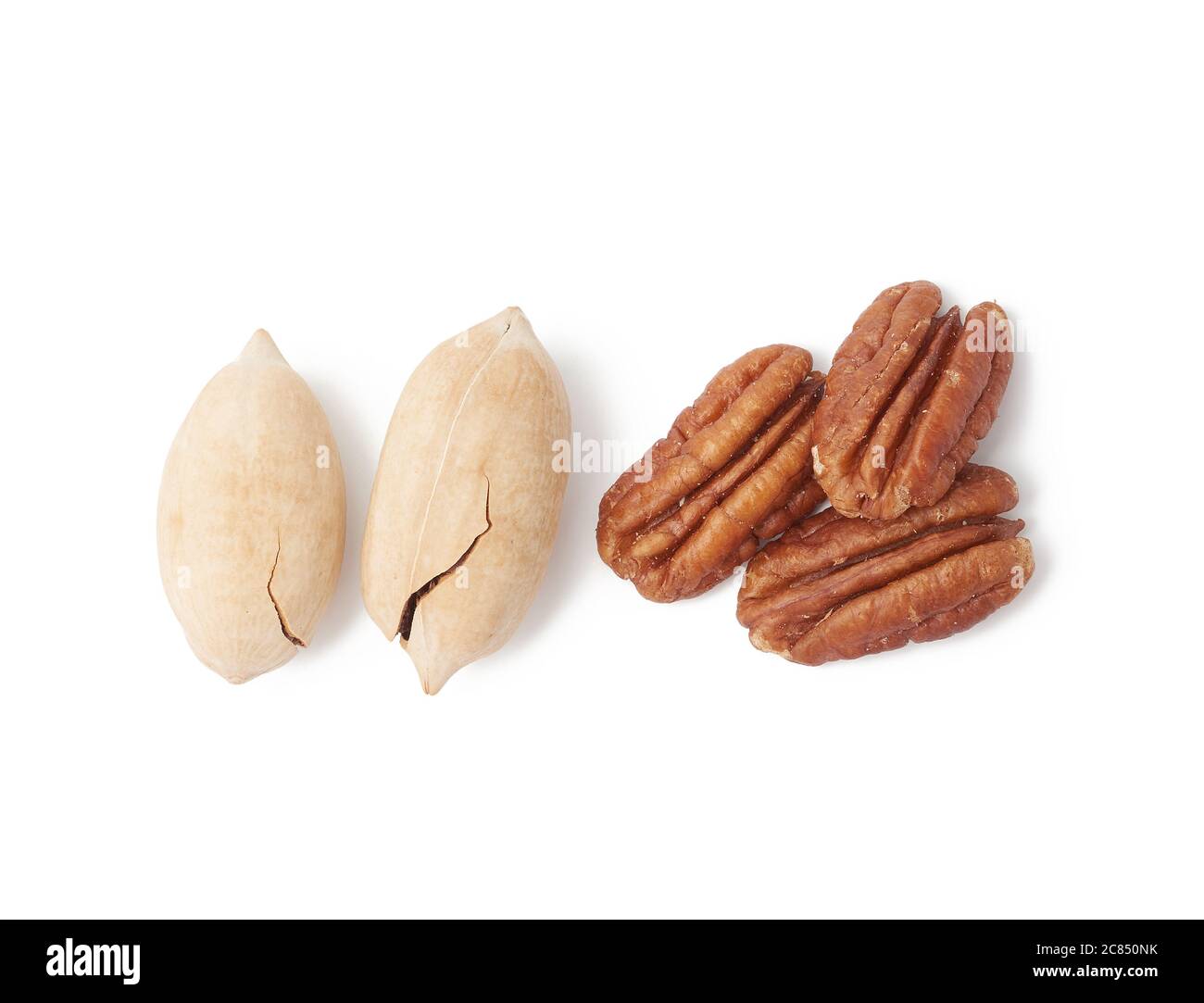 two heaps of peeled and unpeeled pecans on a white background, healthy ...