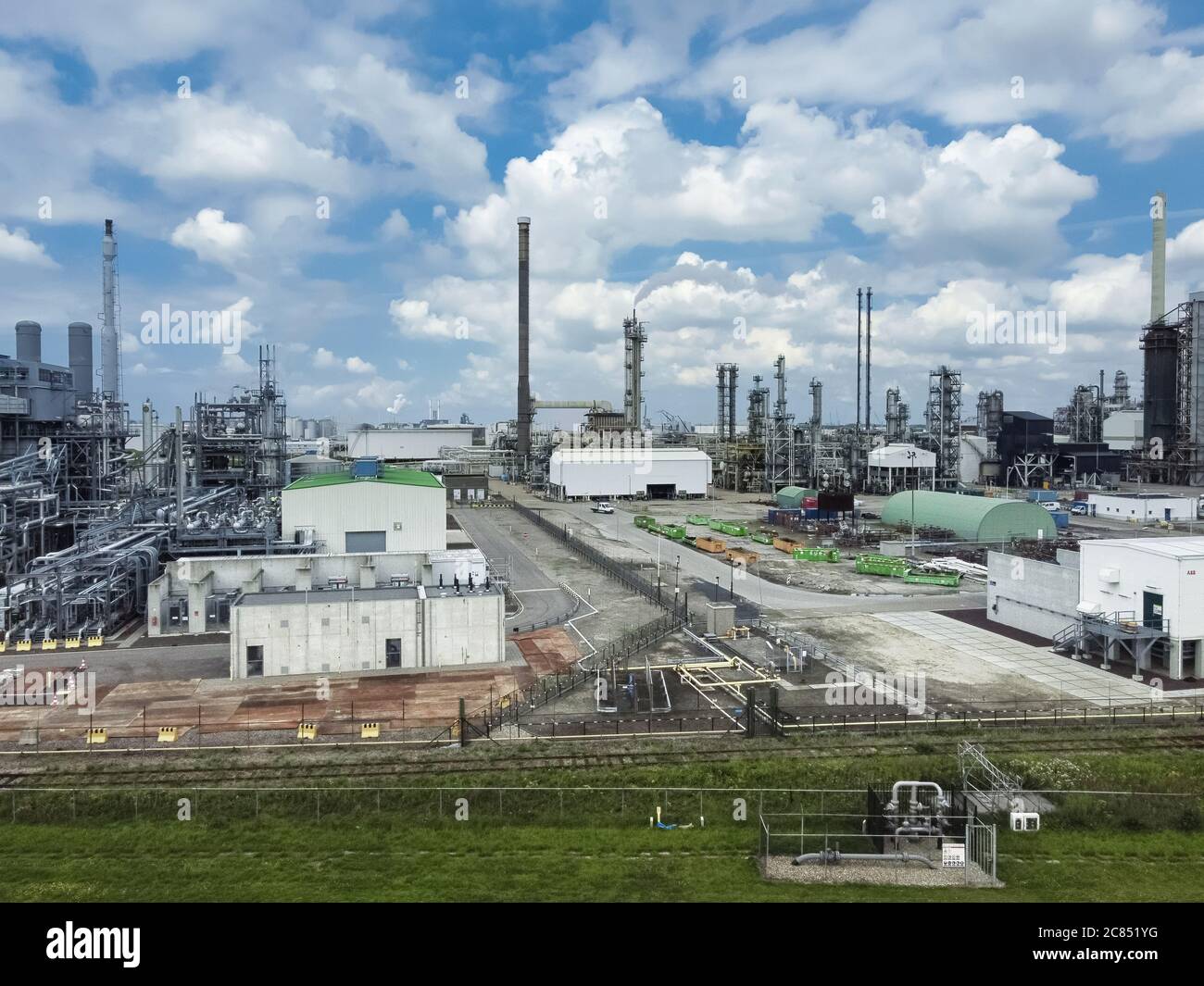 industrial area dominated by chimneys and smoke of the oil refinery ...