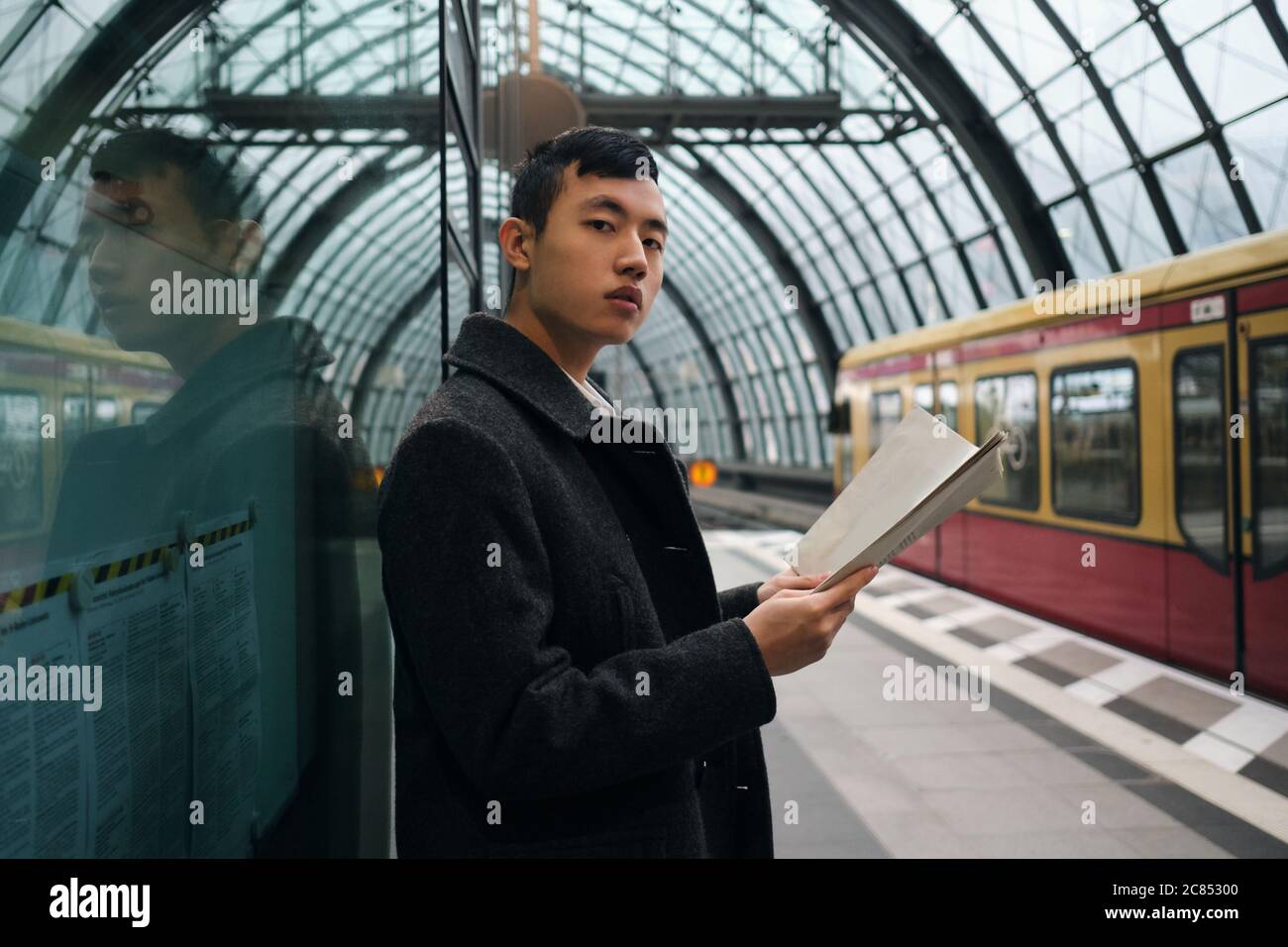 Asian man newspaper train hi-res stock photography and images - Alamy