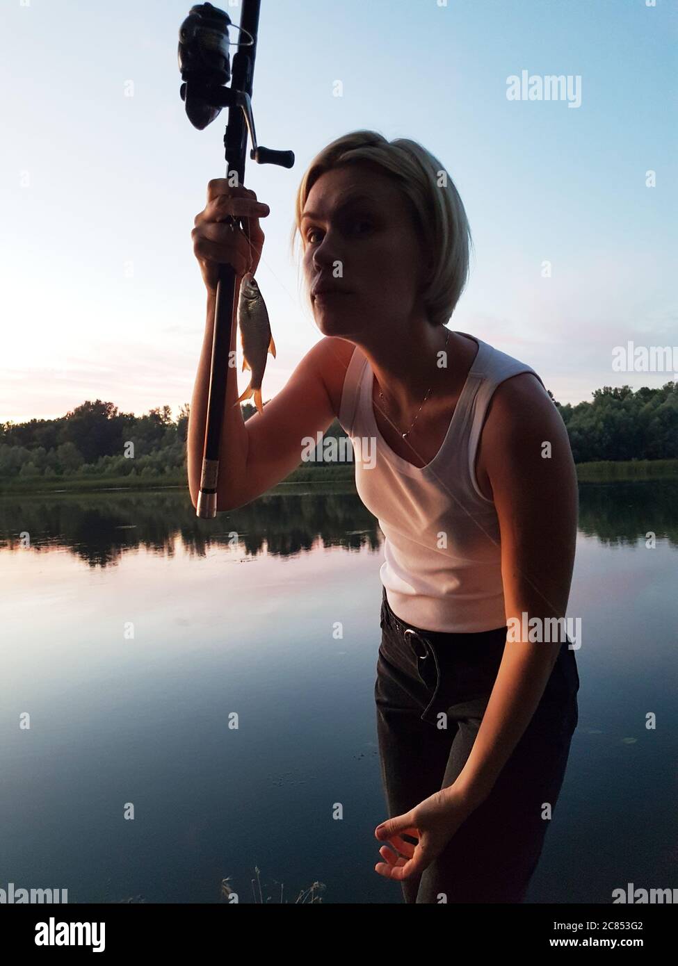 Silhouette woman on dock sunset hi-res stock photography and images - Alamy
