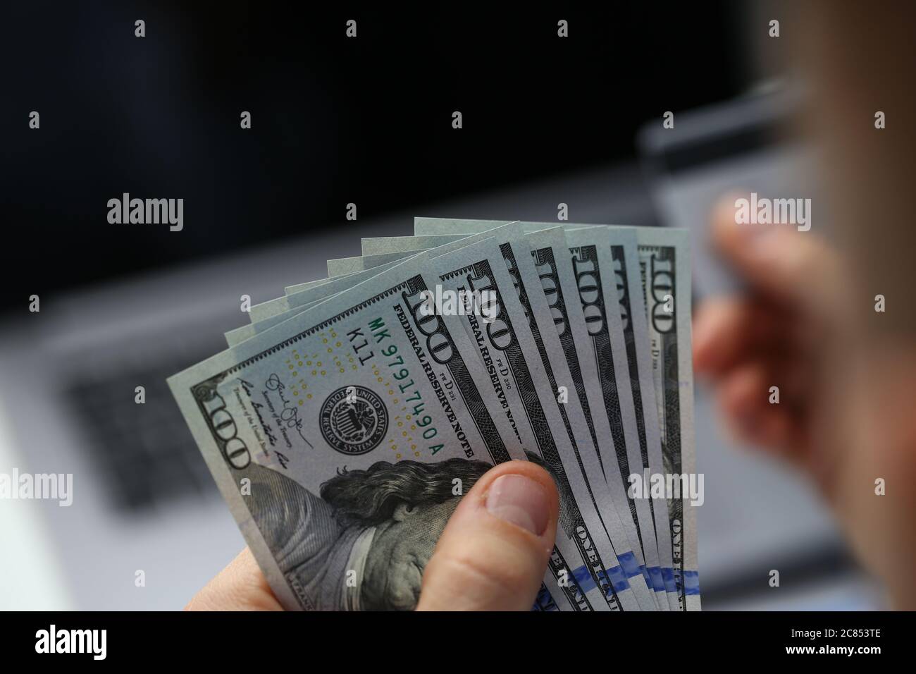 Man calculating bank notes in hands indoors Stock Photo - Alamy