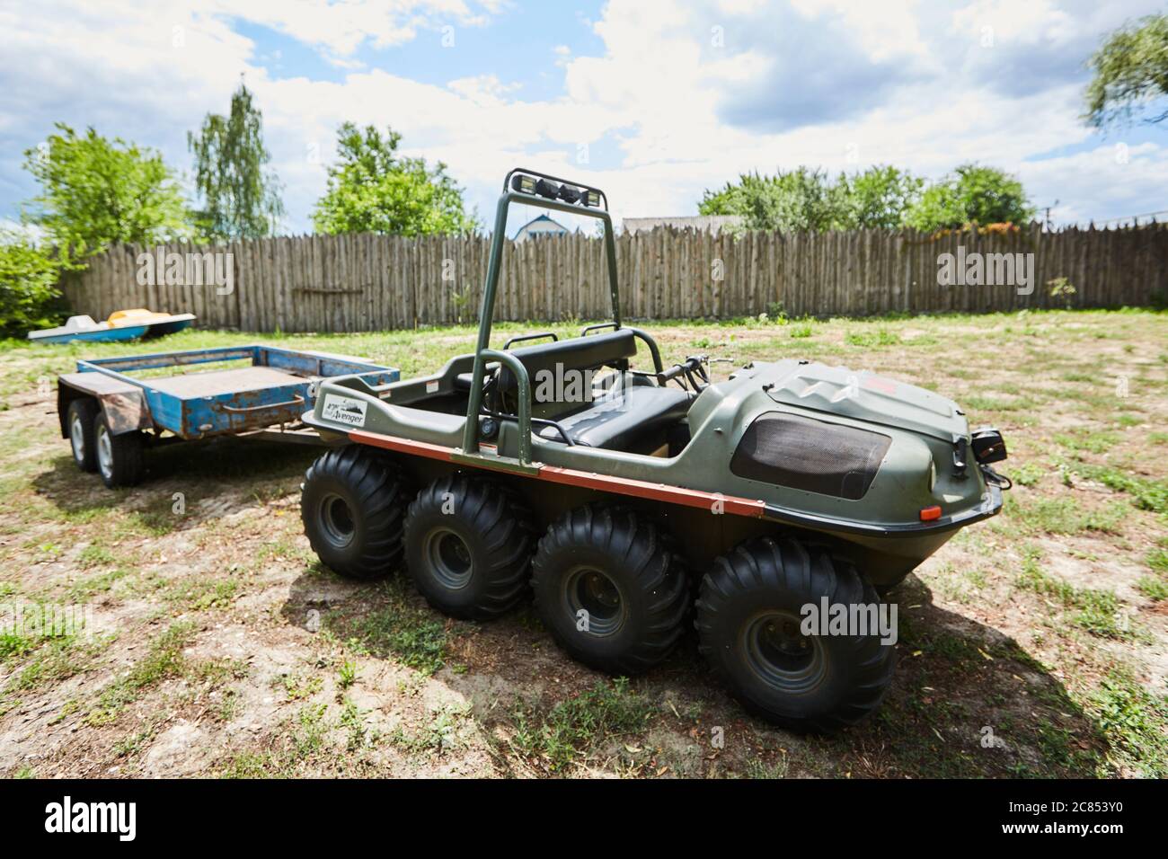 eight-wheeled all-terrain vehicle with a trailer on a meadow on a ...