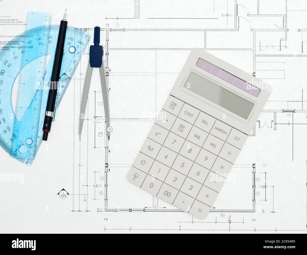 Calculator and blueprint Stock Photo - Alamy