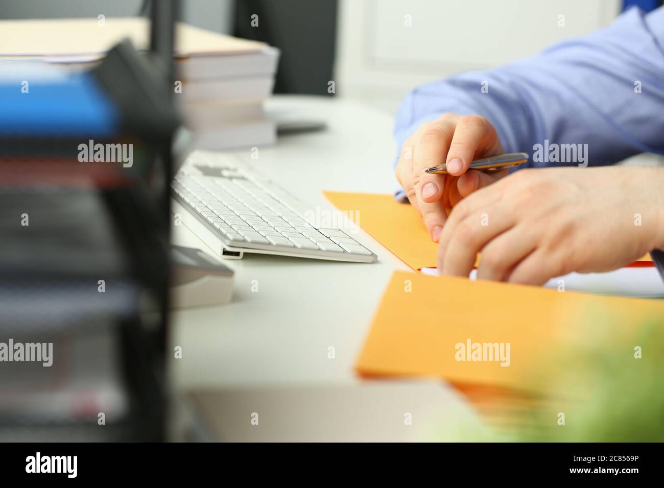 Clerk working at desk with documents and computer Stock Photo - Alamy