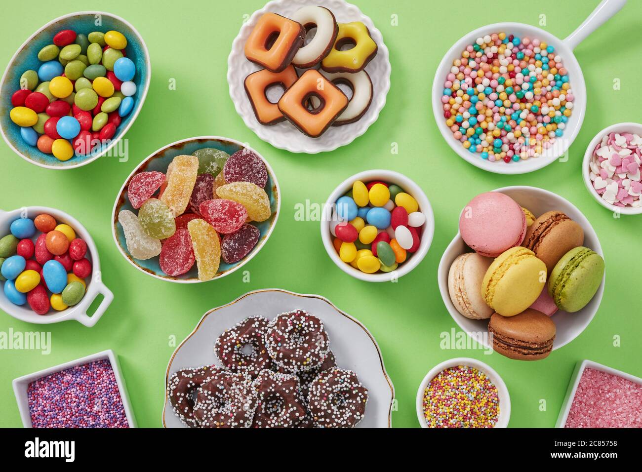 Colored sweets variation on green background Stock Photo - Alamy