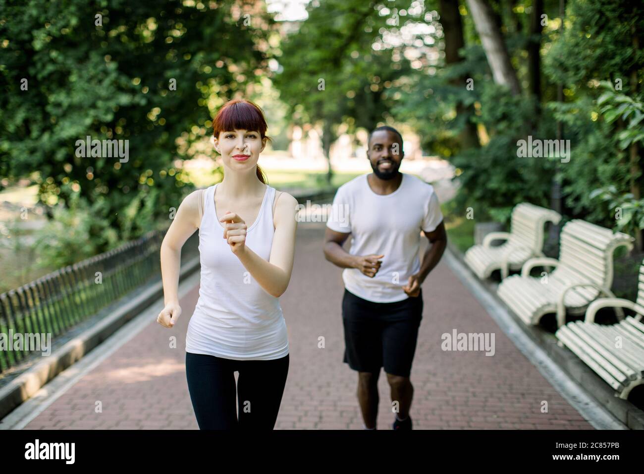 Athletic multiethnical couple, dark skinned man and caucasian red ...