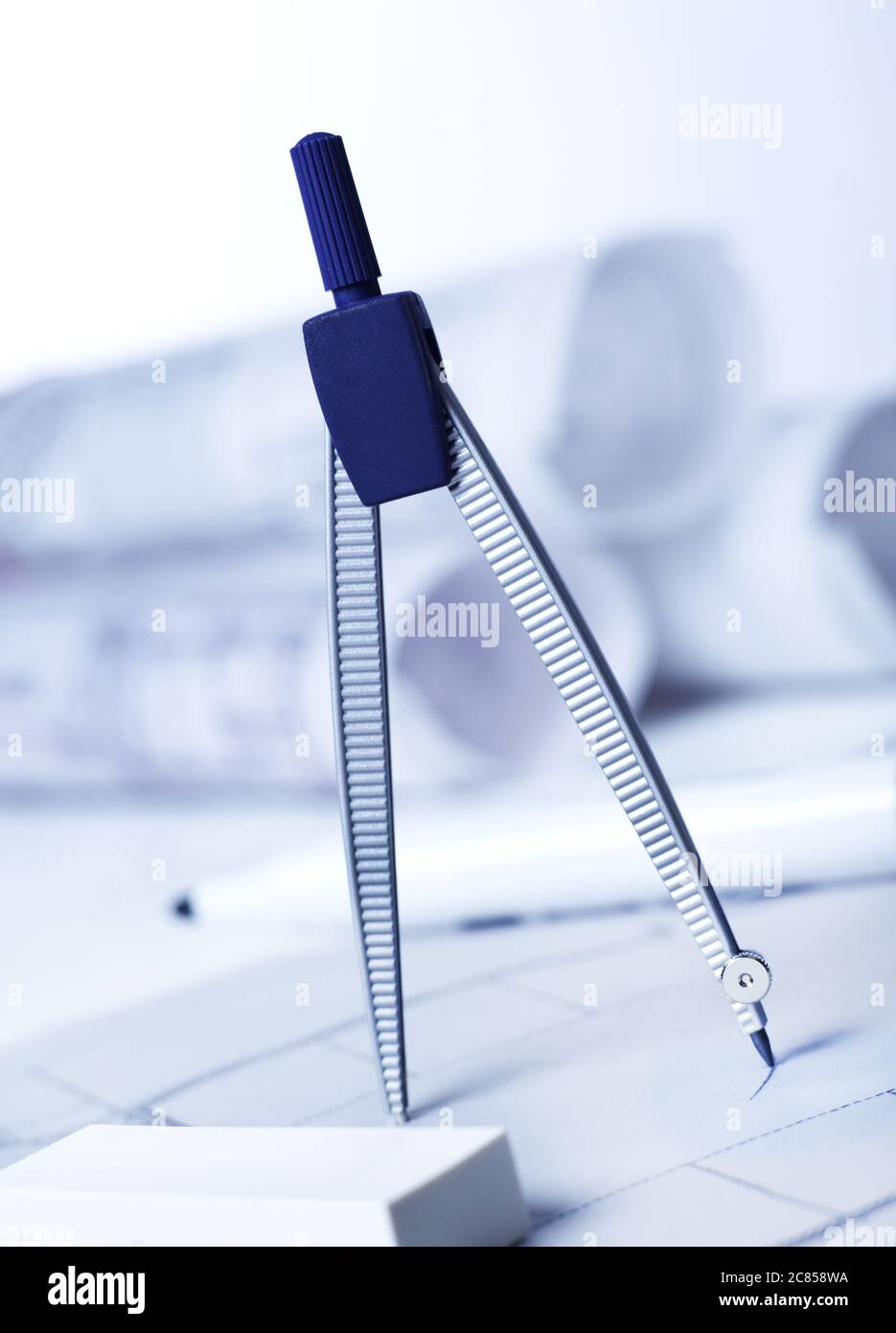 Drawing compass on blueprints Stock Photo - Alamy