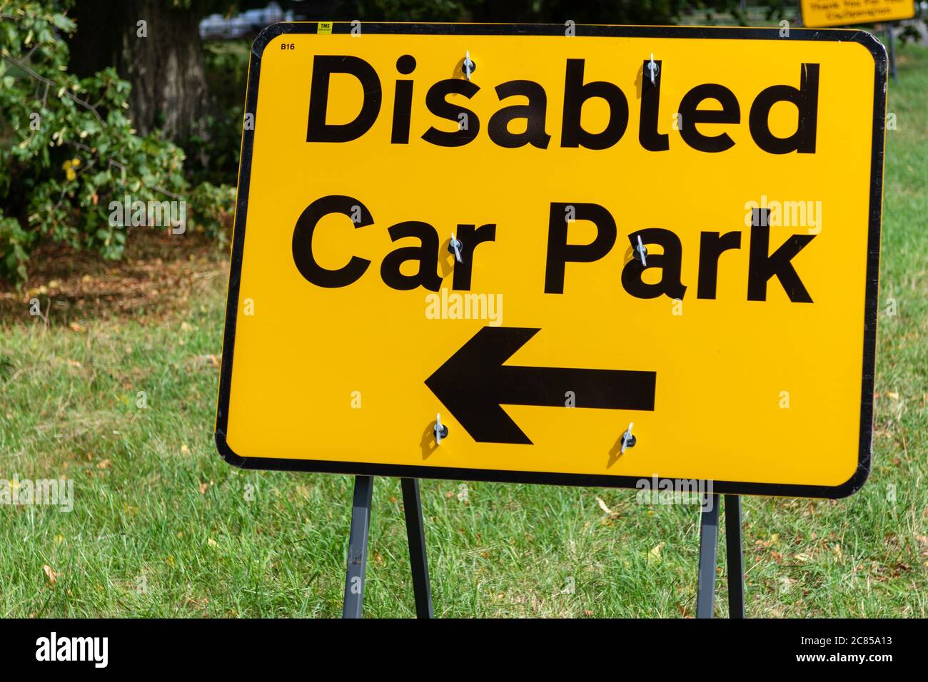 Yellow traffic sign indicates to drivers which way to the disabled car ...