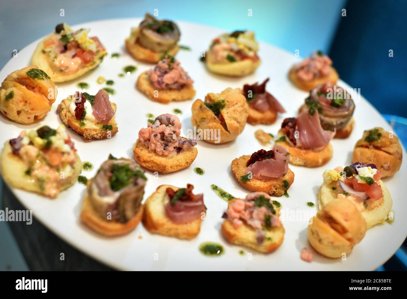canapes of ham, olives and pate on white plate Stock Photo - Alamy