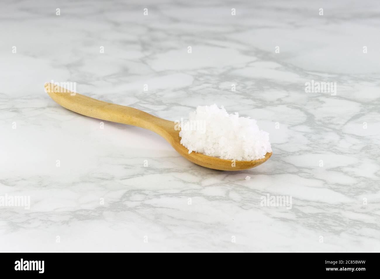 sea salt in wooden spoon on Cement Tiles Stock Photo - Alamy