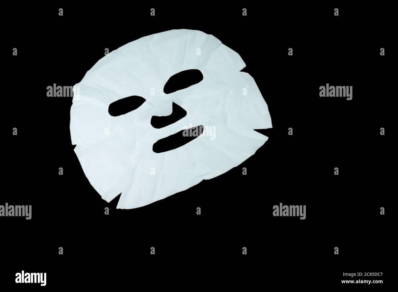 white face mask pad on black background Stock Photo - Alamy