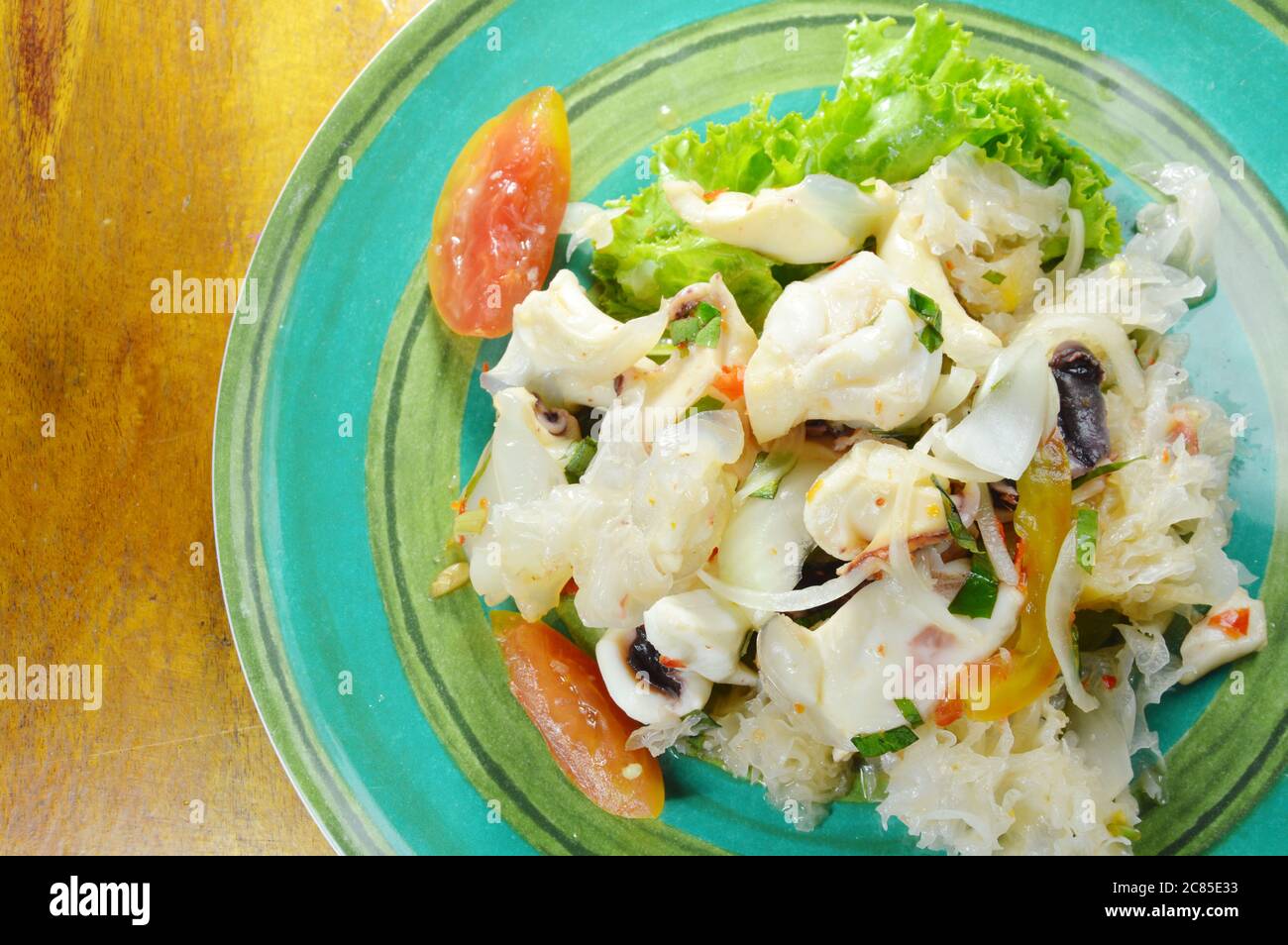 Thai spicy squid salad and fresh vegetable on plate Stock Photo - Alamy