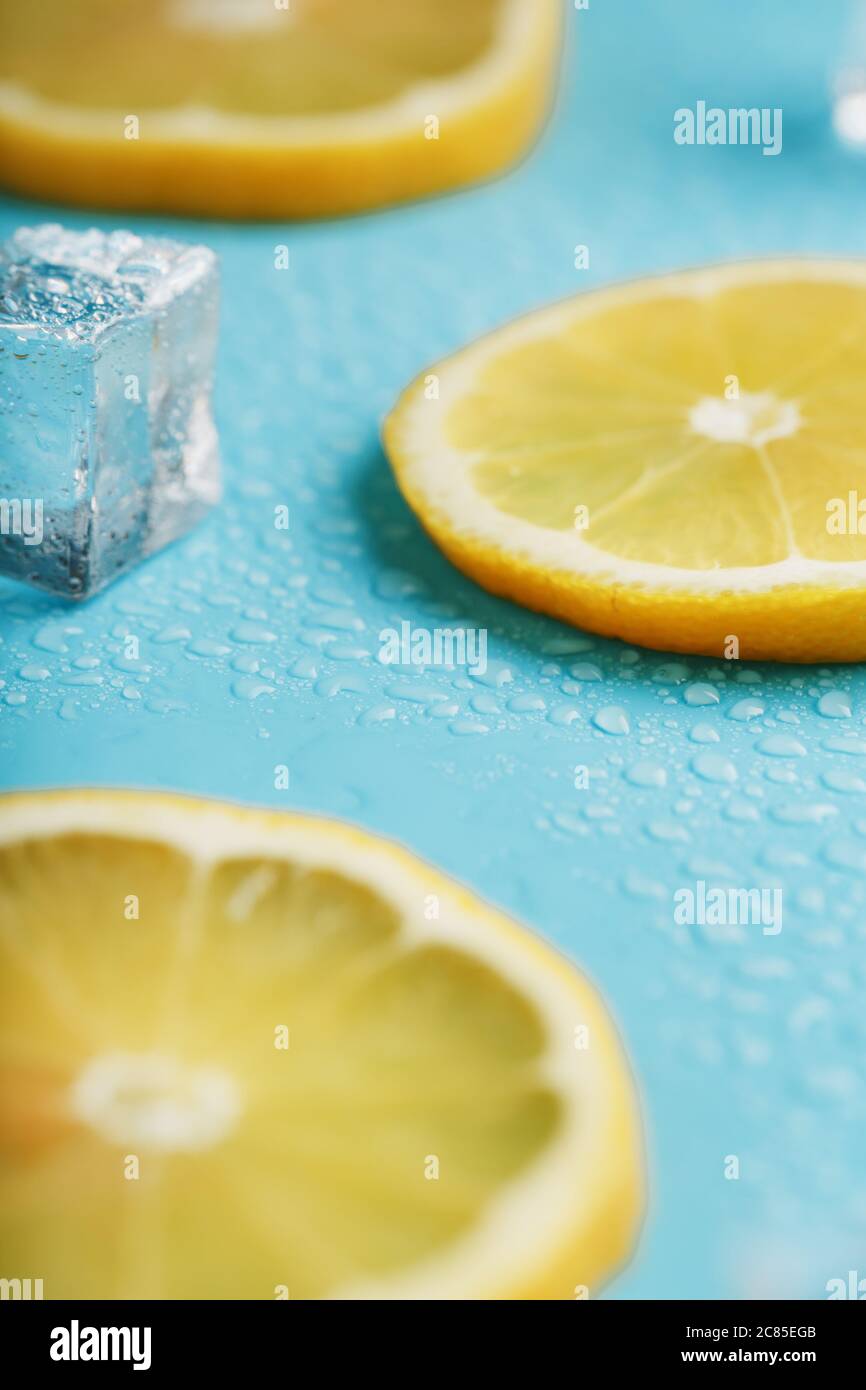 Fresh lemon with ice and drops on a blue background Stock Photo - Alamy