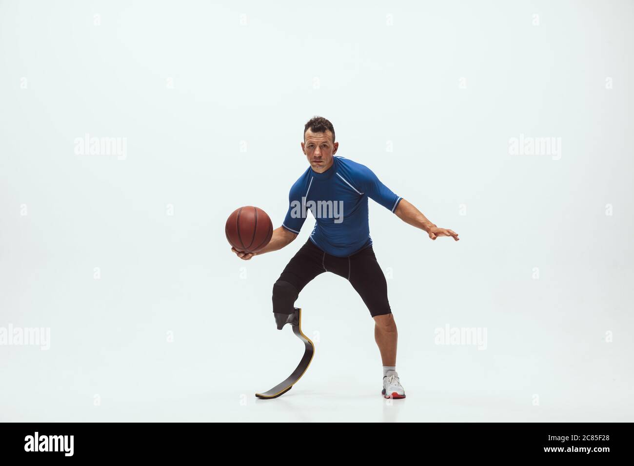 Athlete with disabilities or amputee on white studio background ...