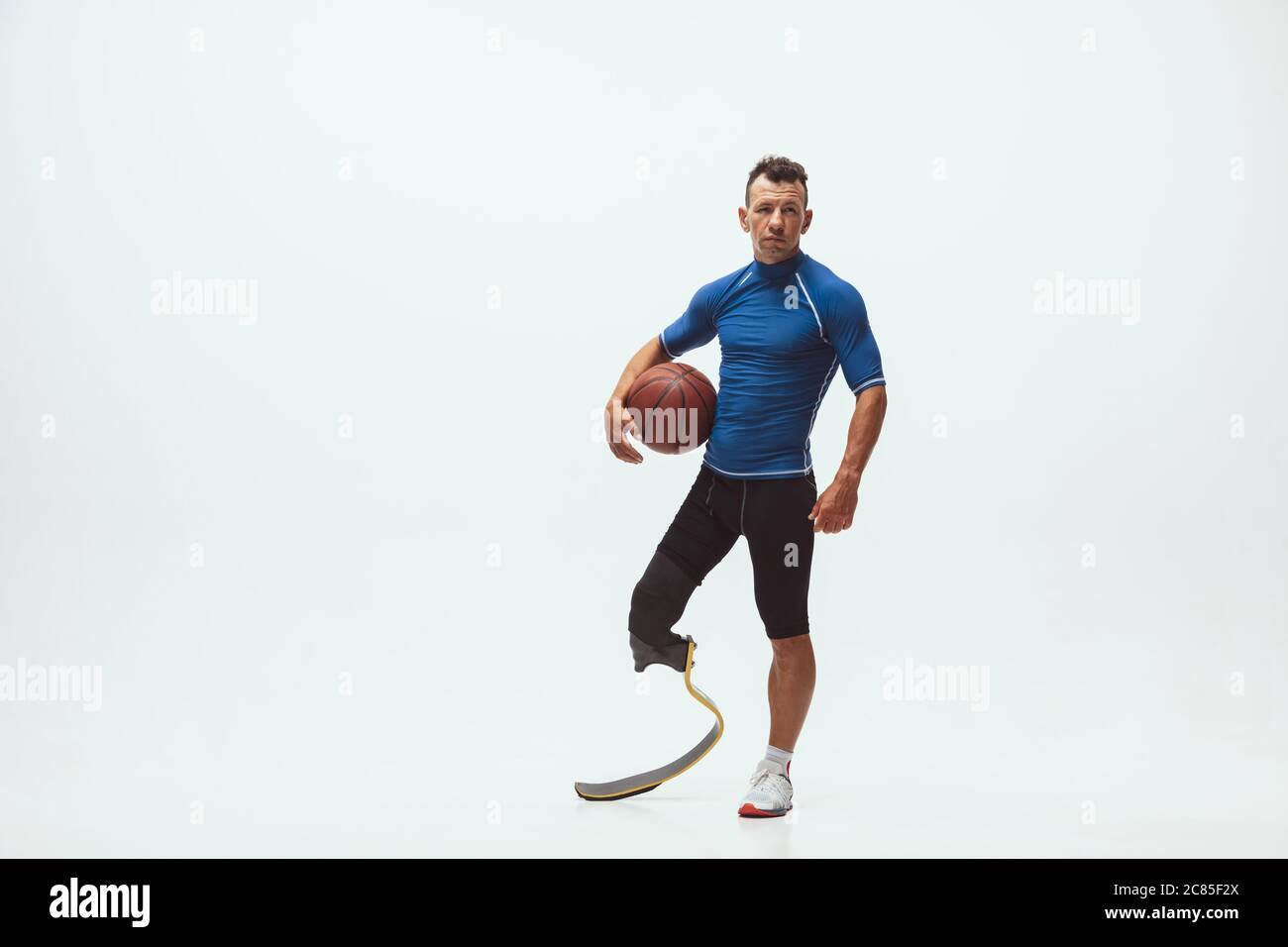 Athlete with disabilities or amputee on white studio background ...