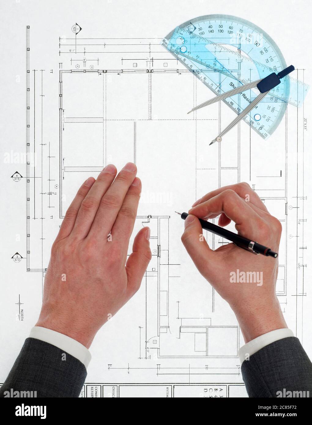 Architect drawing on a blueprint Stock Photo - Alamy
