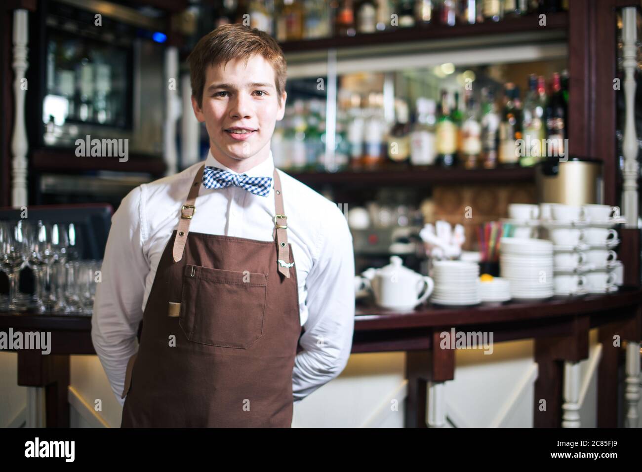 Barman at work in pub,Portrait of cheerful barman worker standing Stock ...