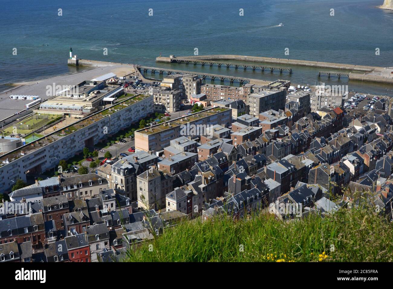 Aerial shot of a city in a bay area with blue ocean in the background ...