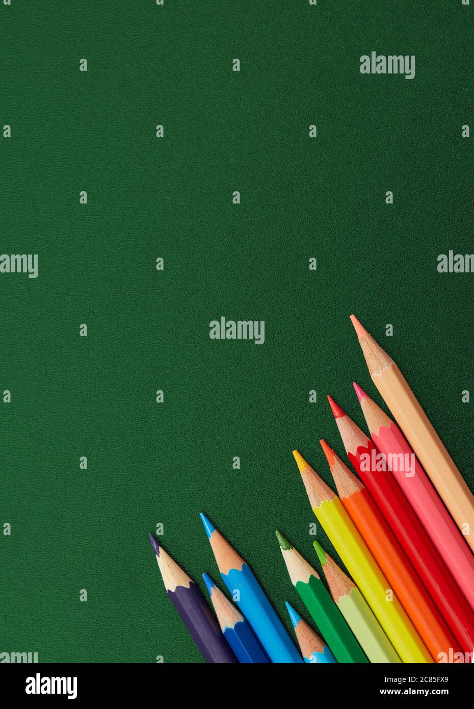 Multi-colored pencils on blackboard Stock Photo - Alamy