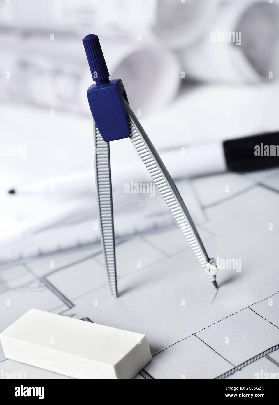 Drawing compass on blueprints Stock Photo - Alamy