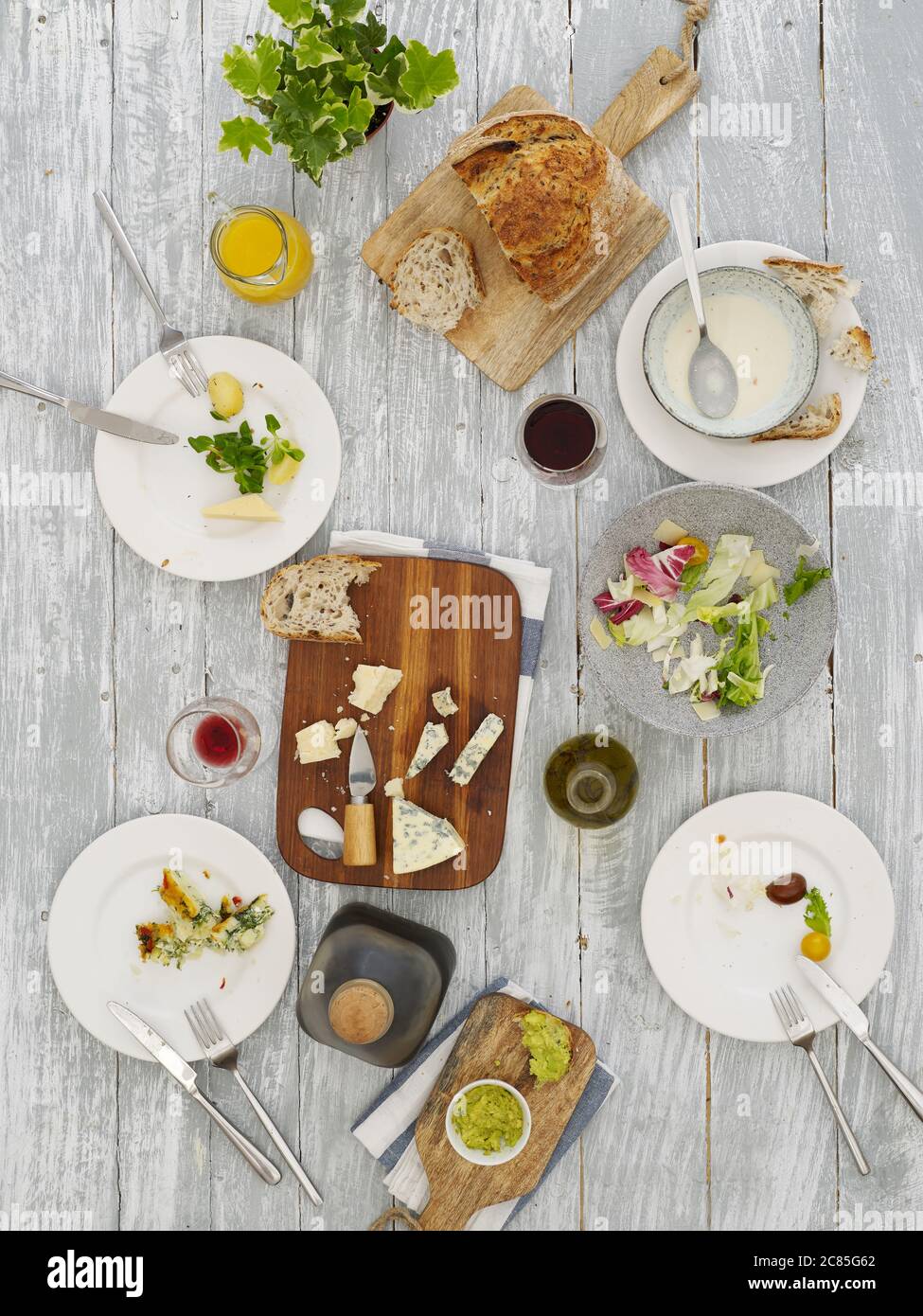 Empty plates on dinner table Stock Photo - Alamy