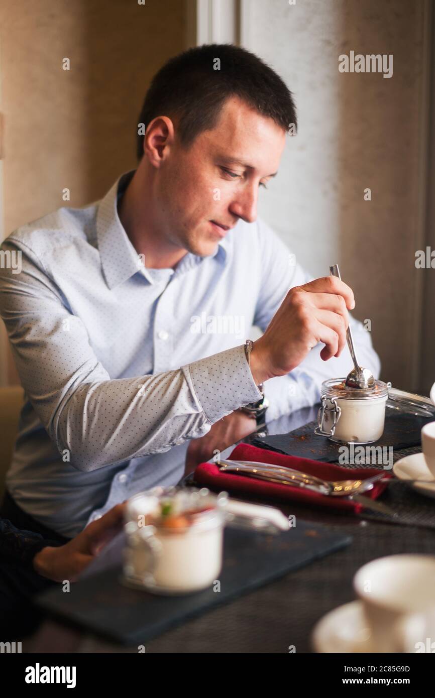 Young man woman eating cake restaurant hi-res stock photography and ...