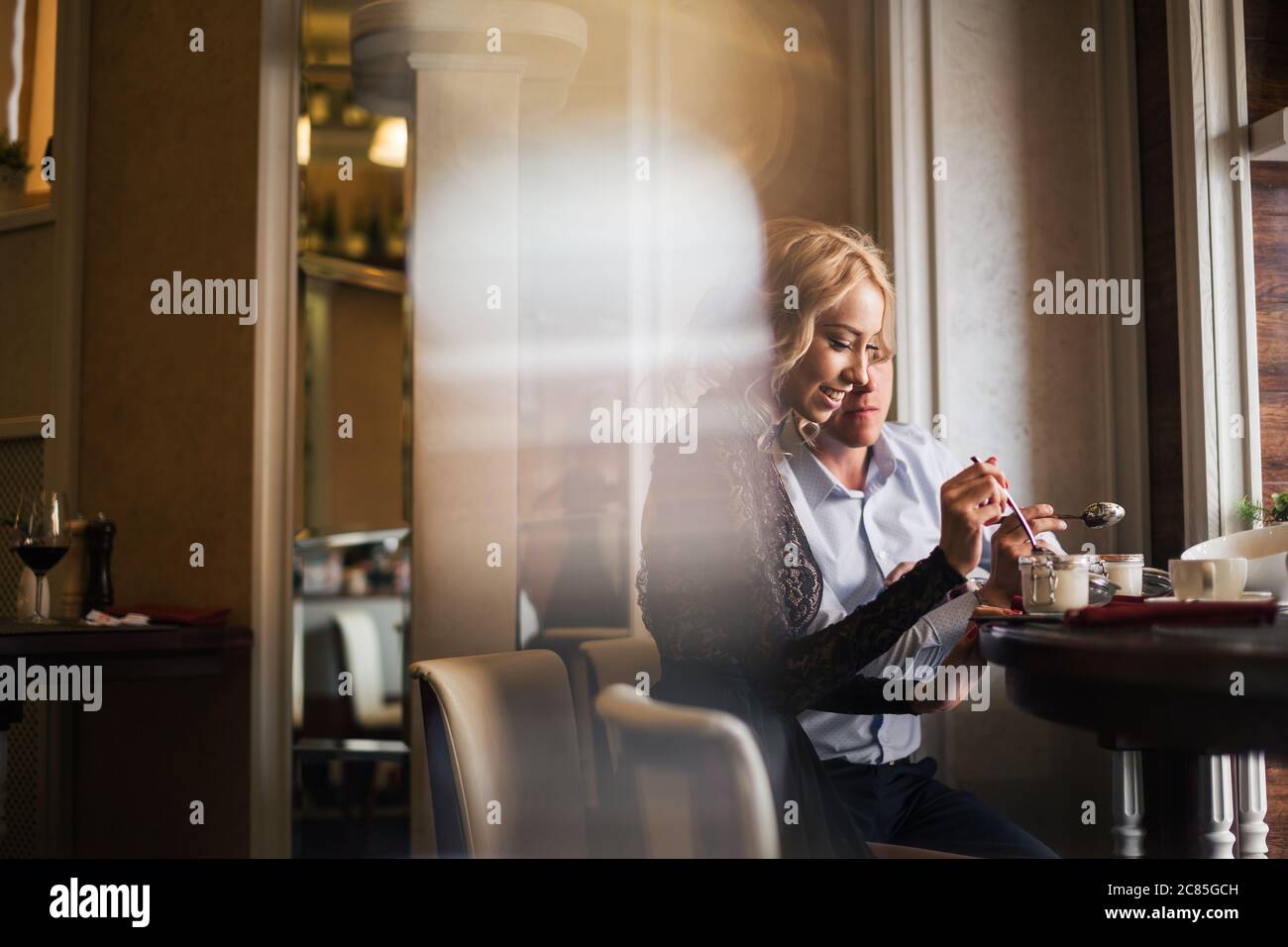 Young man woman eating cake restaurant hi-res stock photography and ...