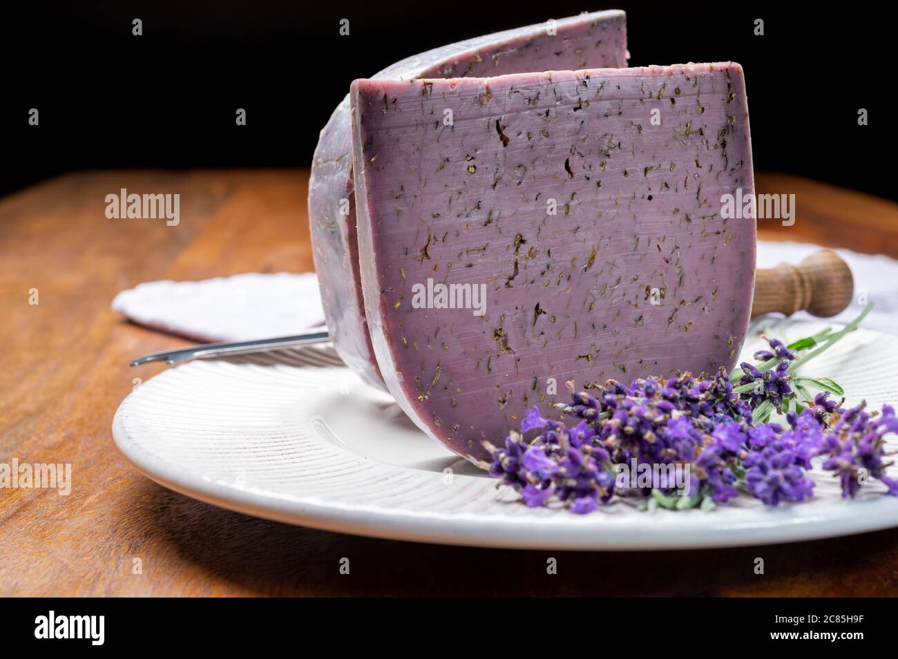 Cheese collection, pieces of violet hard cheese made with aromatic ...