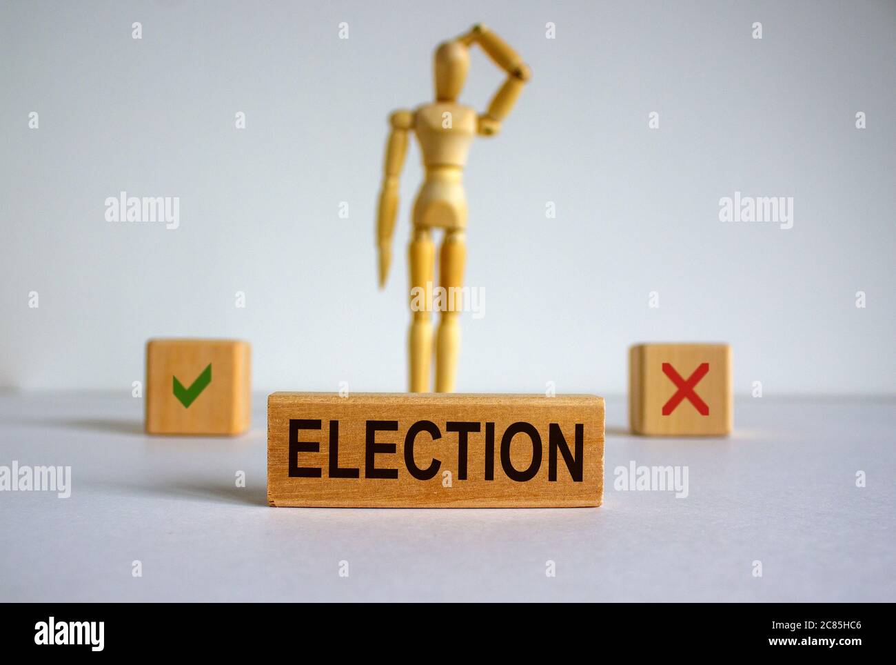 Election word written in wooden block. Wooden model of a man reflecting ...