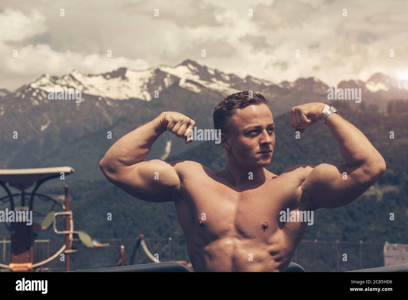 Portrait of a young male bodybuilder with perfect figure showing his ...